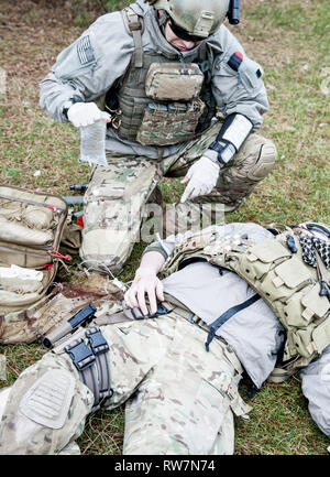 United States Army ranger medic treating the wounds of an injured ...