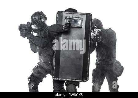 SWAT police special forces hiding behind ballistic shield and smoke ...