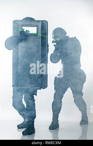 SWAT police special forces hiding behind ballistic shield and smoke ...