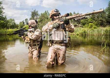 Navy SEALs crossing the river with weapons Stock Photo - Alamy