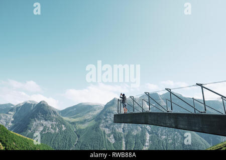 A tourist enjoying the viewpoint at Utsikten along the Gaularfjellet ...