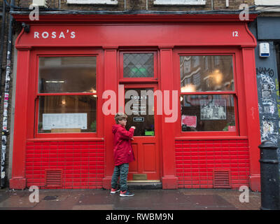 Boy outside sweet shop Stock Photo - Alamy
