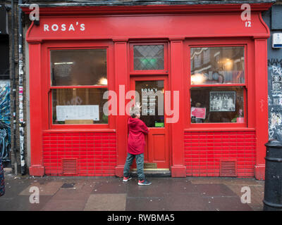 Boy outside sweet shop Stock Photo - Alamy