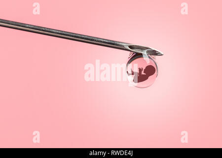 Artificial insemination. Test tube baby, IVF. On the tip of the needle ...