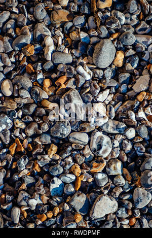 Close up of rounded and polished beach rocks. Pebble stones at the sea ...