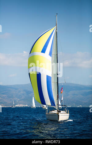 Colorful gennaker sail of a sailing yacht in the wind, sailing on the ...