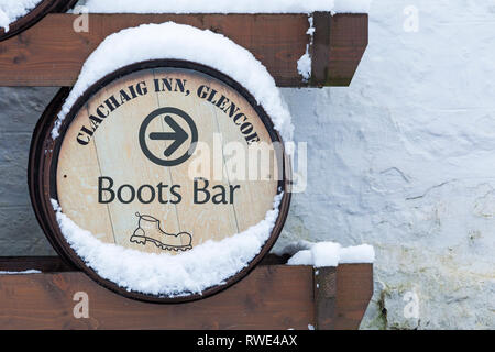 Snow covered whisky barrels outside Clachaig Inn, Glencoe, Argyll ...