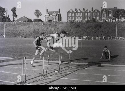 Barriers over a running track in athletics hall Stock Photo - Alamy