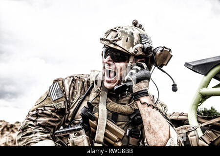 Soldier screaming into radio during a desert battle Stock Photo - Alamy