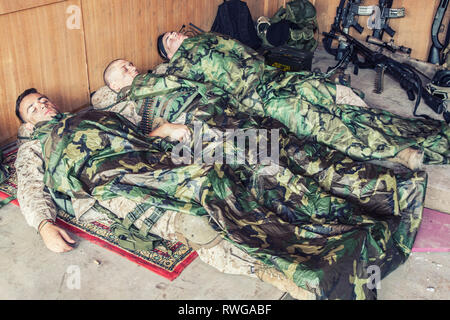 Tired U.S. Marines sleeping on the floor covered with poncho liners and ...