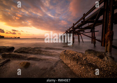 sunset at Atlit beach with a old woden pier, Israel Stock Photo - Alamy