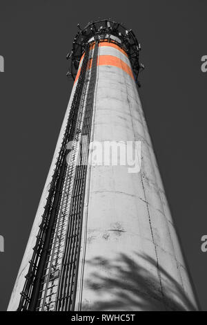 High industrial concrete chimney tower with a cellular ...