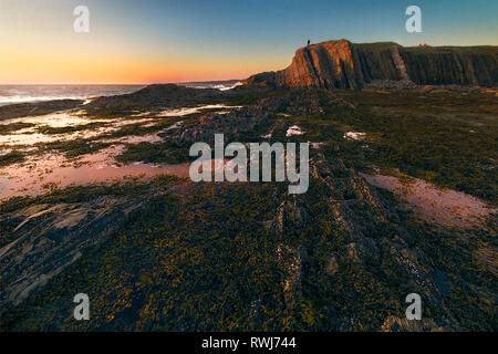 Sun dropping below the horizion at Green Point, Gros Morne National ...