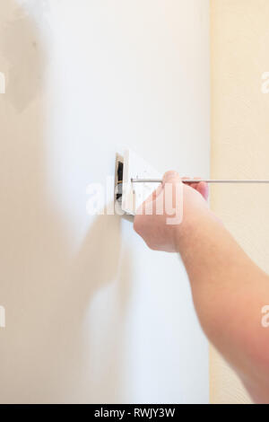 Electrician fitting double socket to stud wall Stock Photo - Alamy