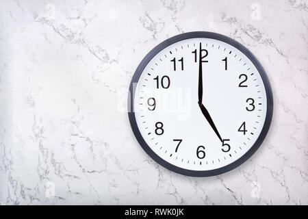 Wall clock show five o'clock on marble texture. Office clock show 5pm ...
