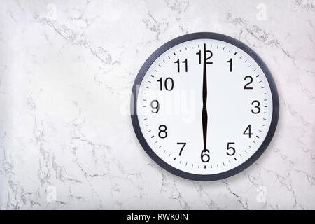 Wall clock show six o'clock on marble texture. Office clock show 6pm or ...
