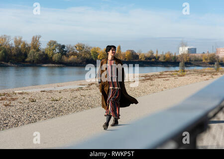 Woman walking along Rhine River, Strandbad, Mannheim, Germany Stock ...