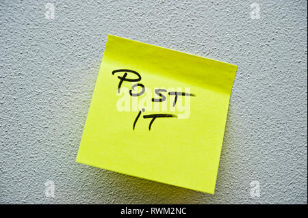 post-it yellow note with word POST IT scribbled on it Stock Photo - Alamy