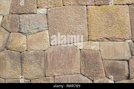 Ancient japanese stone wall made of rocks with dry grass as background ...