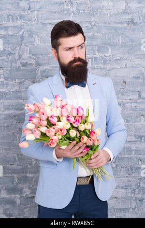 Flower for March 8. Bearded man with tulip flower bouquet. Love date ...
