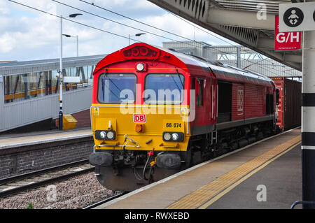 DB Class 66 heads a southbound train of containers through Peterborough ...