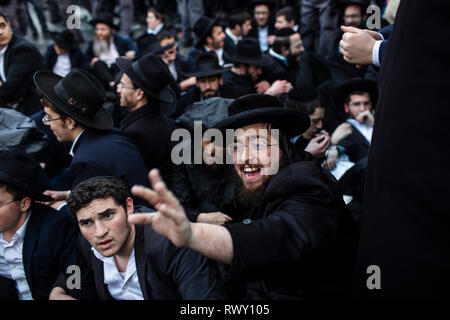 Ultra-Orthodox Jewish men block a road during a protest against army ...