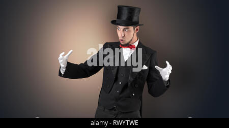 Handsome magician with no graph holds something invisible Stock Photo ...