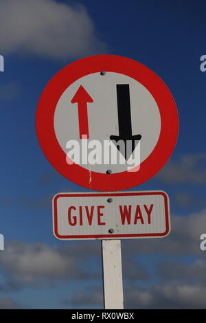 Single lane traffic, give way, UK Urban road sign Stock Photo - Alamy