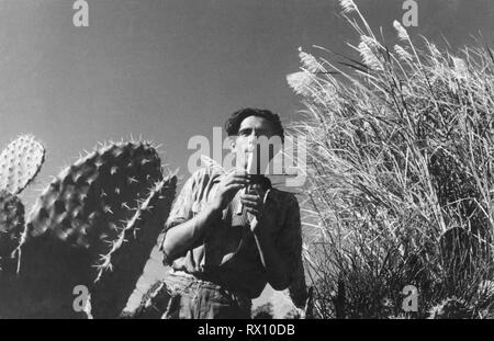 A historical photograph of shepherds playing a flute, depicting rural ...