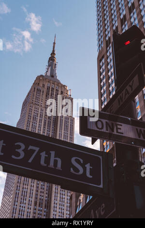 A view of street name direction signs in background of old building ...