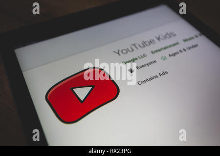 YouTube Kids app logo on Google Play store is shown on tablet screen ...