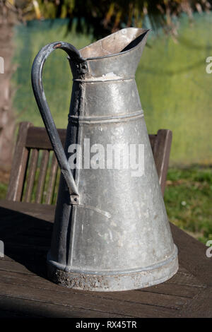 an antique zinc metal pitcher, outdoors Stock Photo - Alamy