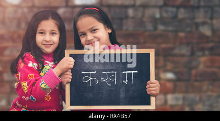 Hindi concept with little girl student against the India flag ...