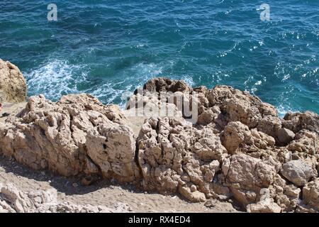 Blue and azure sea waters and rocky cliff Stock Photo - Alamy