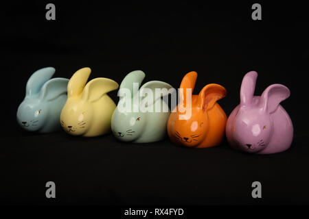 Colourful ceramic rabbits on a black background Stock Photo - Alamy