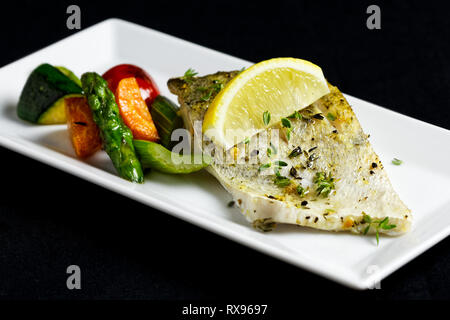 Grilled zander fillet with mixed grilled vegetables on white ...