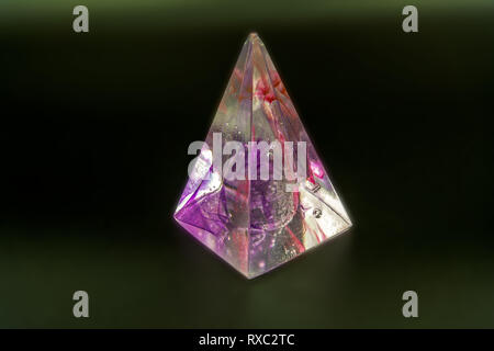 red Glass pyramid prism on black background Stock Photo - Alamy