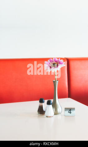 Empty salt, pepper shakers on orange background Stock Photo - Alamy