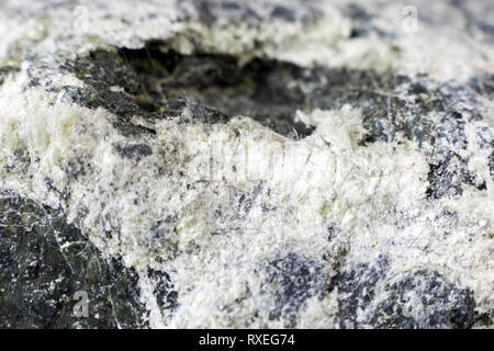 Asbestos fibers in rock close-up. Isolated. Harmful, dangerous minral ...
