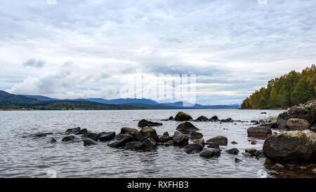 shoreline view with rocks of Loch Rannoch Scotland and the a distant ...