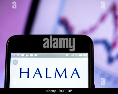 The Halma plc logo is seen on an LED screen in the background while a ...