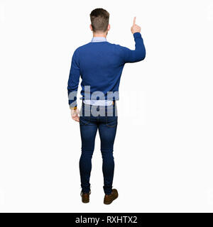 Young handsome bussines man Pointing to both sides with fingers ...