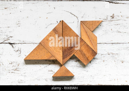 Tangram puzzle in vulture or turkey shape on old white wood background ...