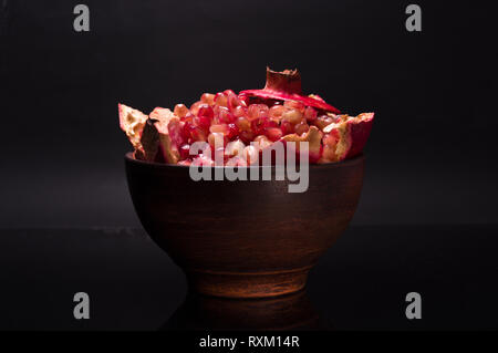 Peeled pomegranate fruit. Pomegranate fruit in a clay bowl. Fron Stock ...