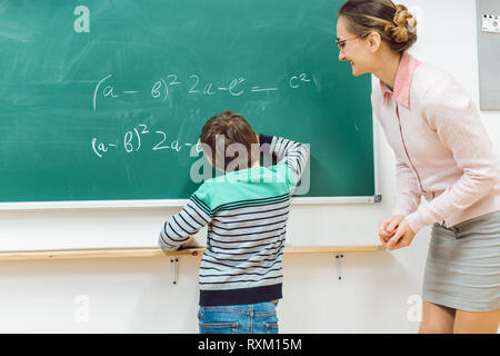 Students doing math work in classroom Stock Photo - Alamy