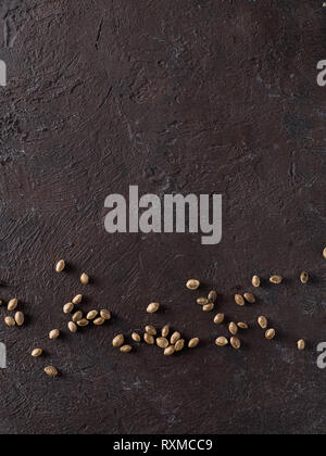 Hemp seeds top view. Unpeeled raw organic hemp seed on black background ...