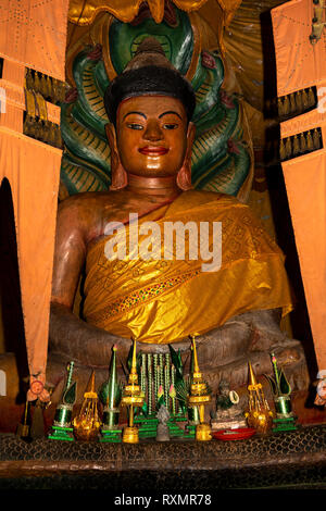 Altar and buddha statue, in an abandoned temple, a dusty clutter and ...