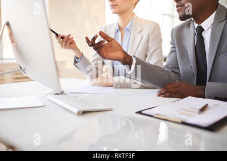 Young elegant businesswoman making presentation to colleagues in modern ...