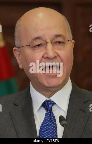 Baghdad, Iraq. 11th Mar, 2019. Iraqi President Barham Salih (R) speaks ...