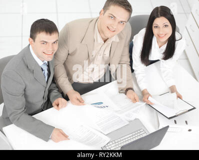 employees discussing financial charts Stock Photo - Alamy